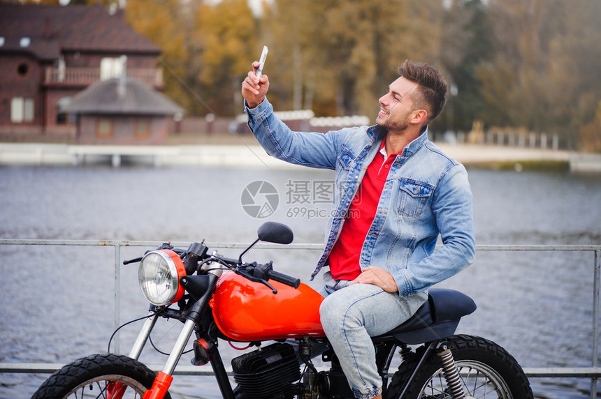 穿着牛仔夹克骑摩托车的时尚男子高清图片下载 正版图片502526661 摄图网