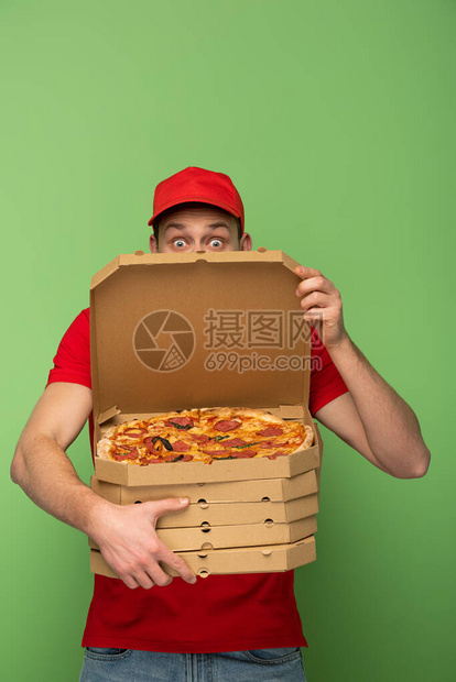 身穿红色制服的送货员在绿色披萨盒后躲藏在绿高清图片下载 正版图片502712904 摄图网