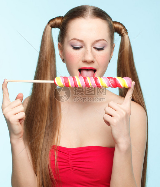 蓝色背景中舔棒糖的漂亮俏高清图片下载-正版图片503191361-摄图网