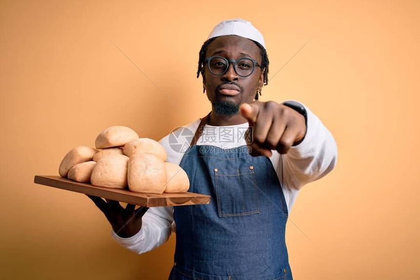 年轻的非洲裔美国面包师穿着围裙拿着托盘高清图片下载-正版图片504620002-摄图网