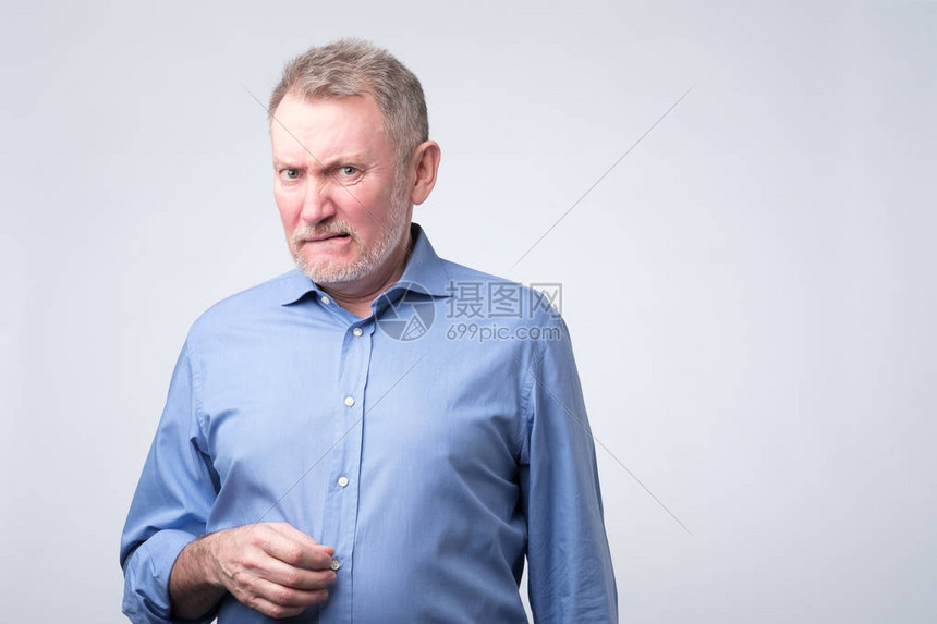怀疑不信任不信任的概念穿着蓝色衬衫的老人带着难以置信的表情看着灰色工作室背景人类情感高清图片下载-正版图片505815047-摄图网