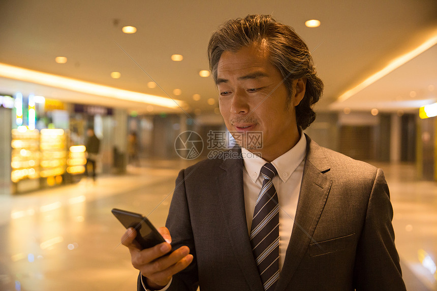 商务男士看手机高清图片下载-正版图片507663380-摄图网
